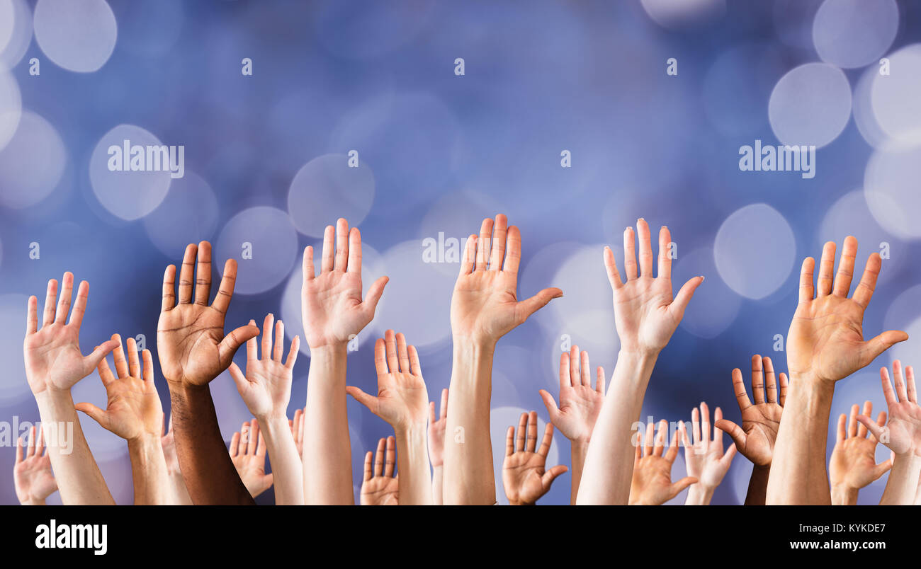 Crowd Raising Hands High Up Against Bokeh Background Stock Photo - Alamy