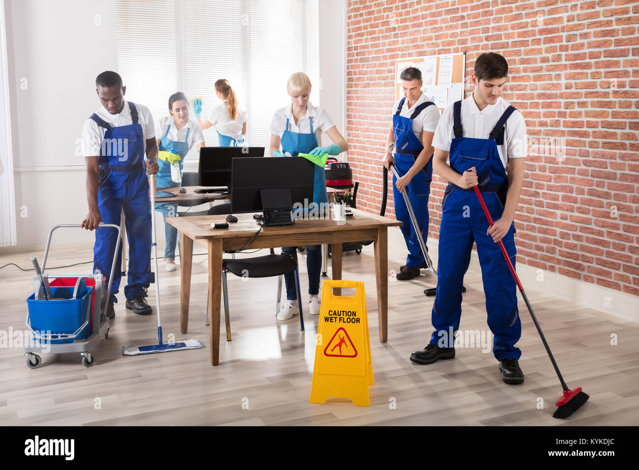 Group Of Janitors In Uniform Cleaning The Office With Cleaning ...