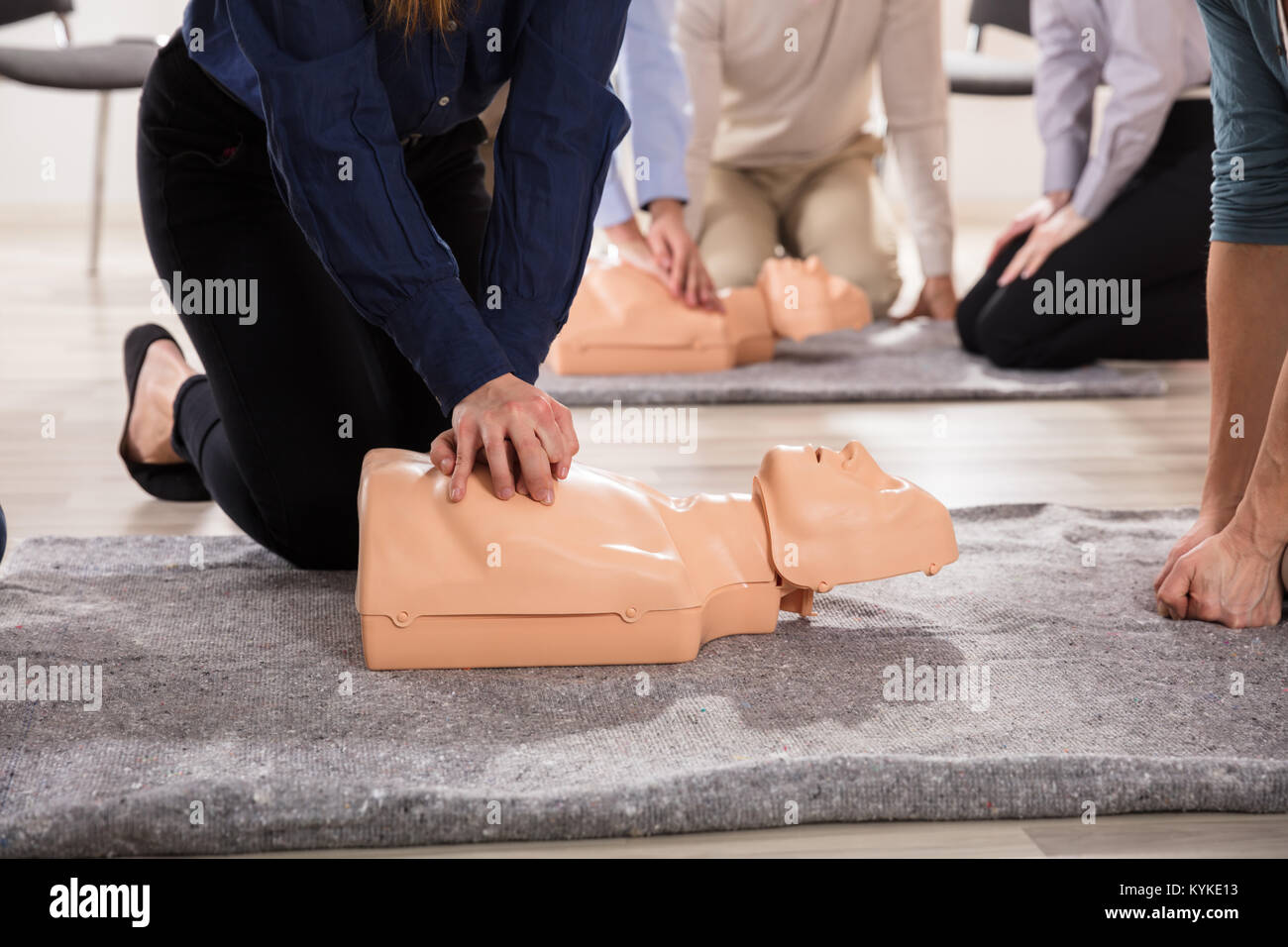 Young Students Practicing CPR Chest Compression On Dummy Stock Photo ...