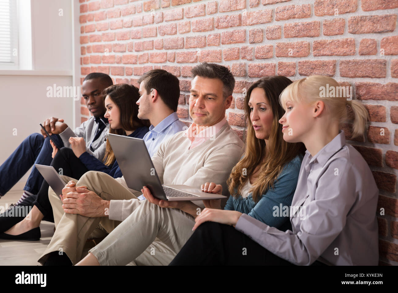Group Of Diverse Businesspeople Using Laptops And Digital Tablets Stock ...