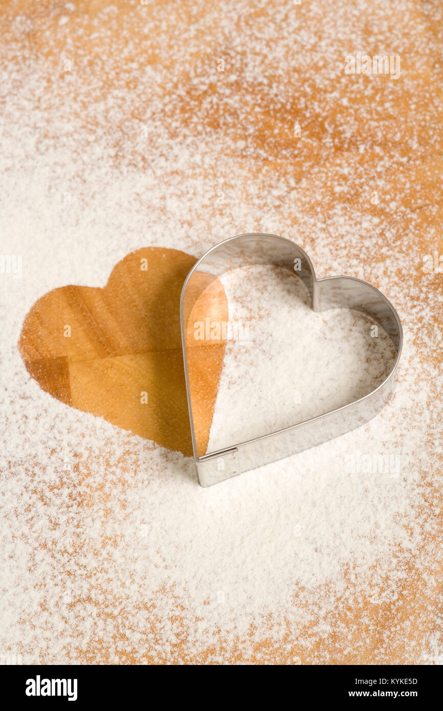 A single heart shaped cookie cutter on a flour background Stock Photo ...