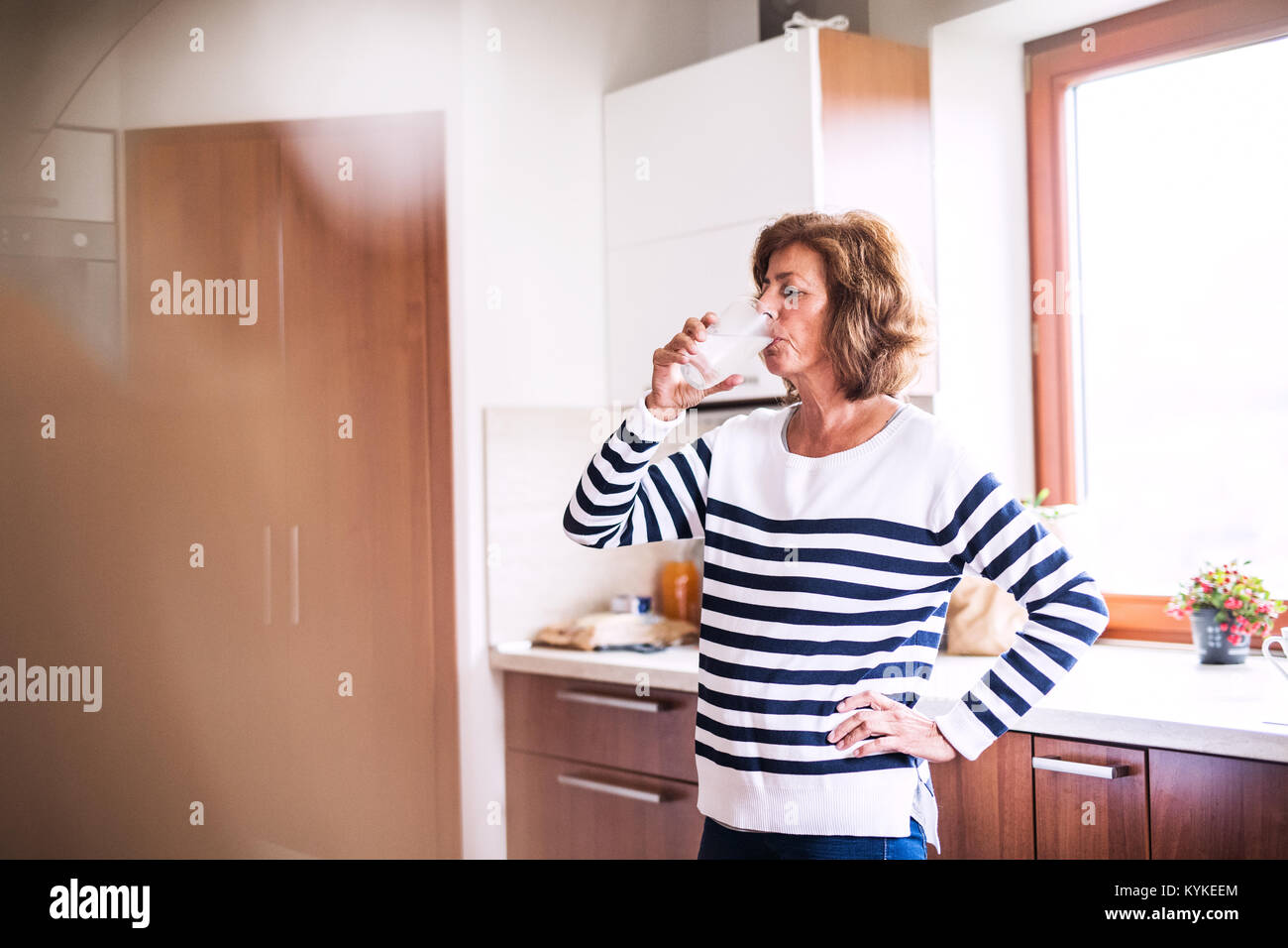 Woman drinking water in home hi-res stock photography and images - Alamy