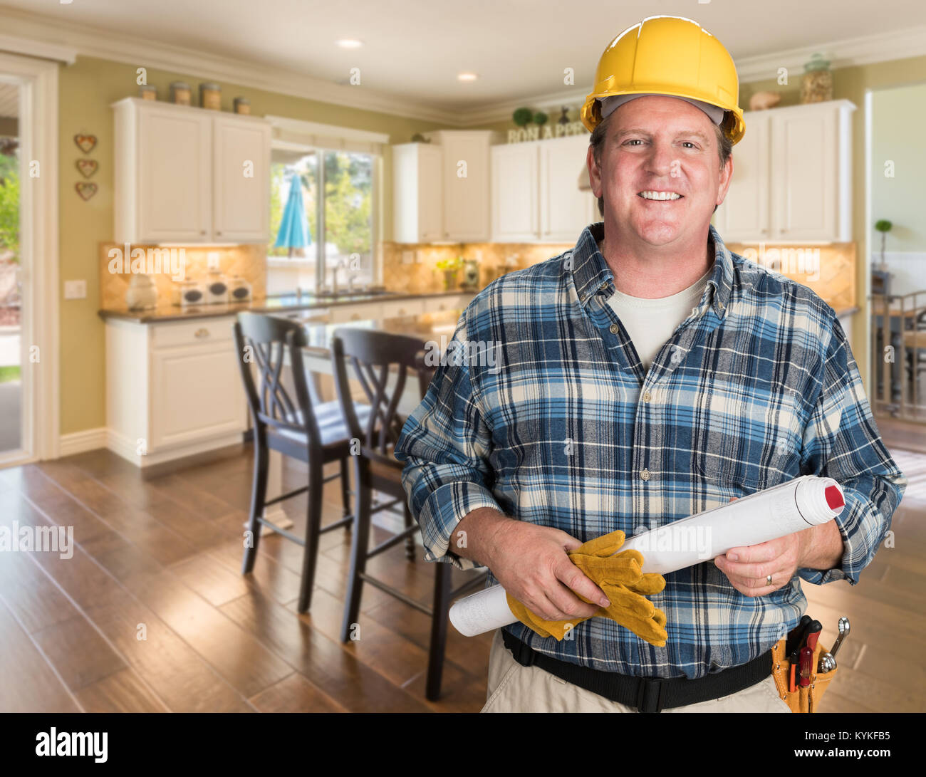 Contractor With Plans and Hard Hat Inside Custom Kitchen Stock Photo ...
