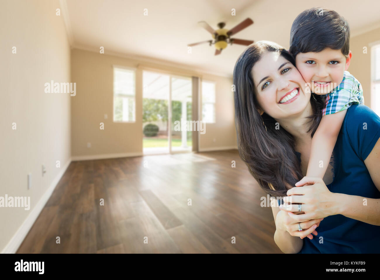 Young Mother and Son Inside Empty Room with Wood Floors Stock Photo - Alamy