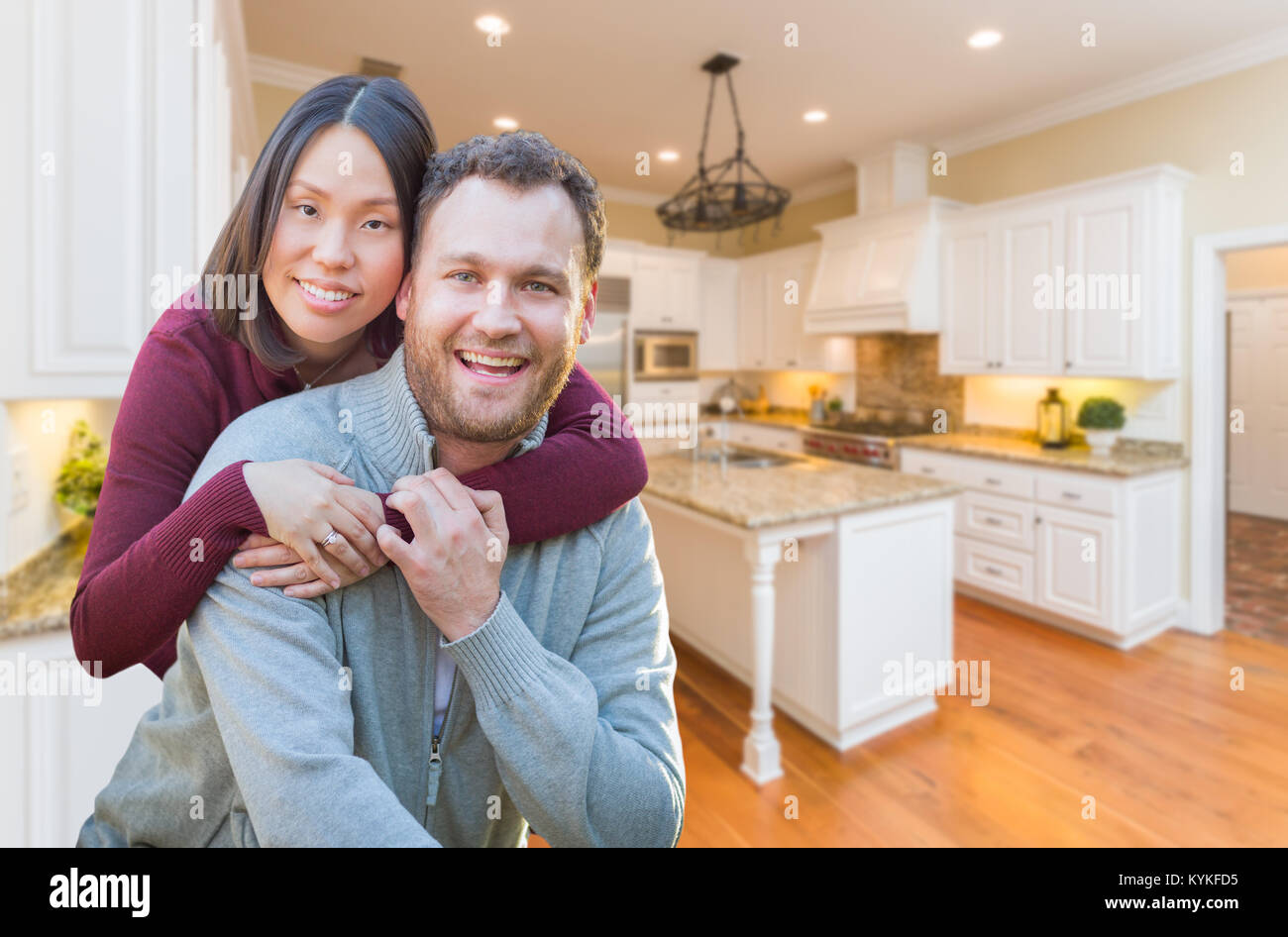 Mixed Race Caucasian and Chinese Couple In Front of Custom Kitchen ...