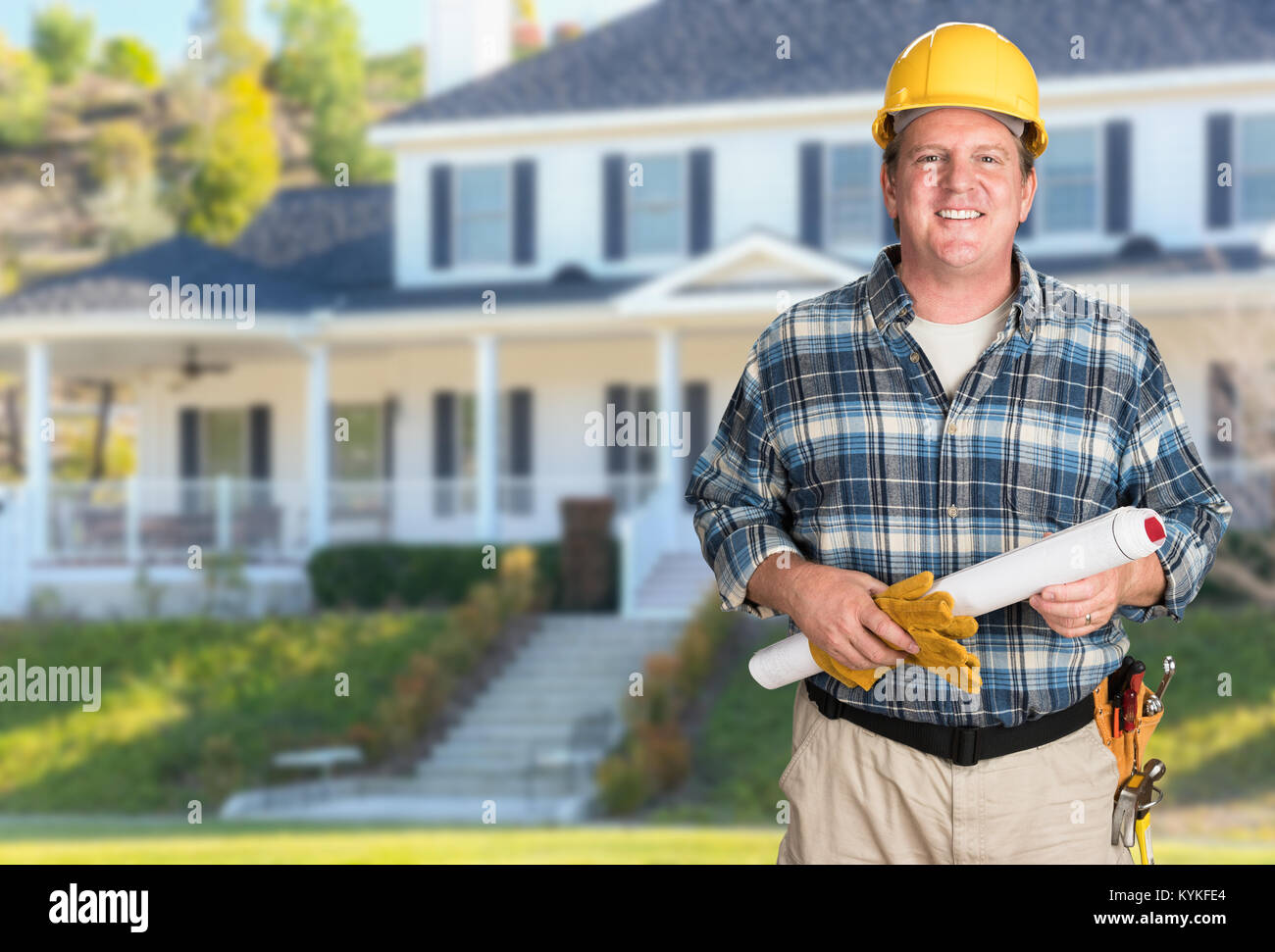 Contractor With Plans and Hard Hat In Front of Beautiful Custom House ...