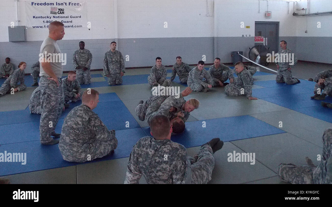Sgt. 1st Class Amy Parker demonstrates a combatives move as other ...