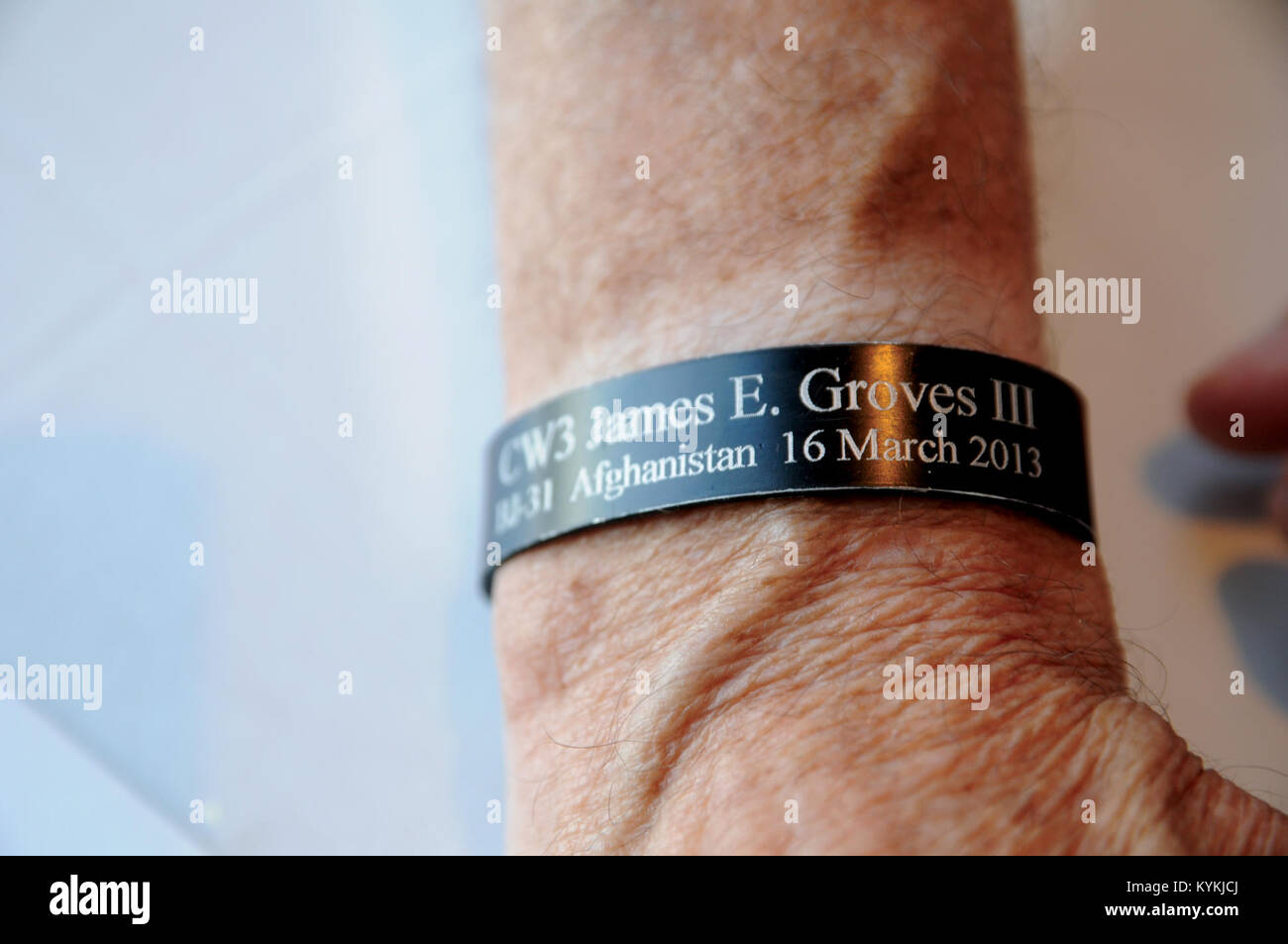 James Groves II, poses for a picture with his bracelet representing his ...