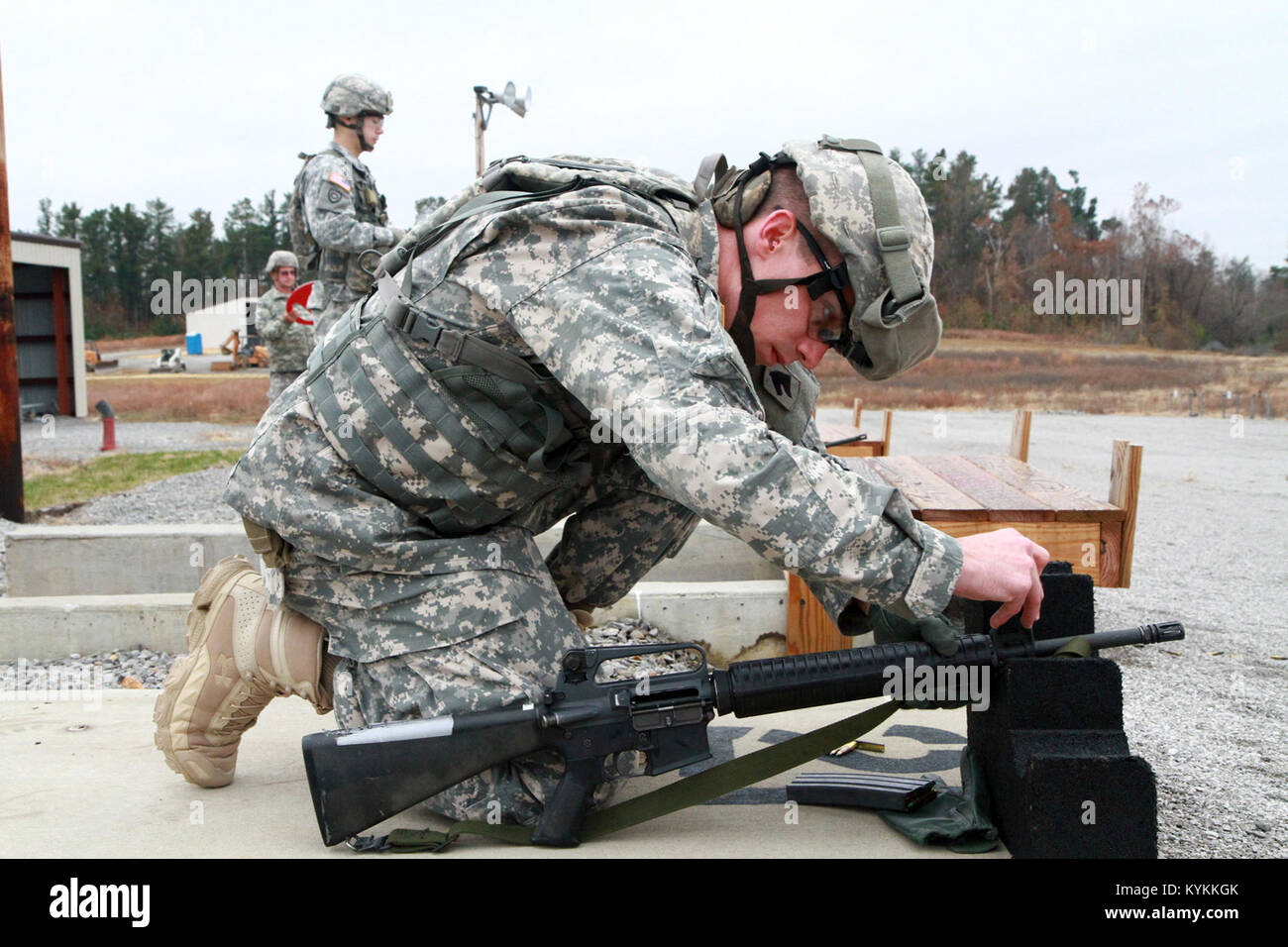 Spc. Benjamin Joynt makes an adjustment to his M-16 during the 2014 ...