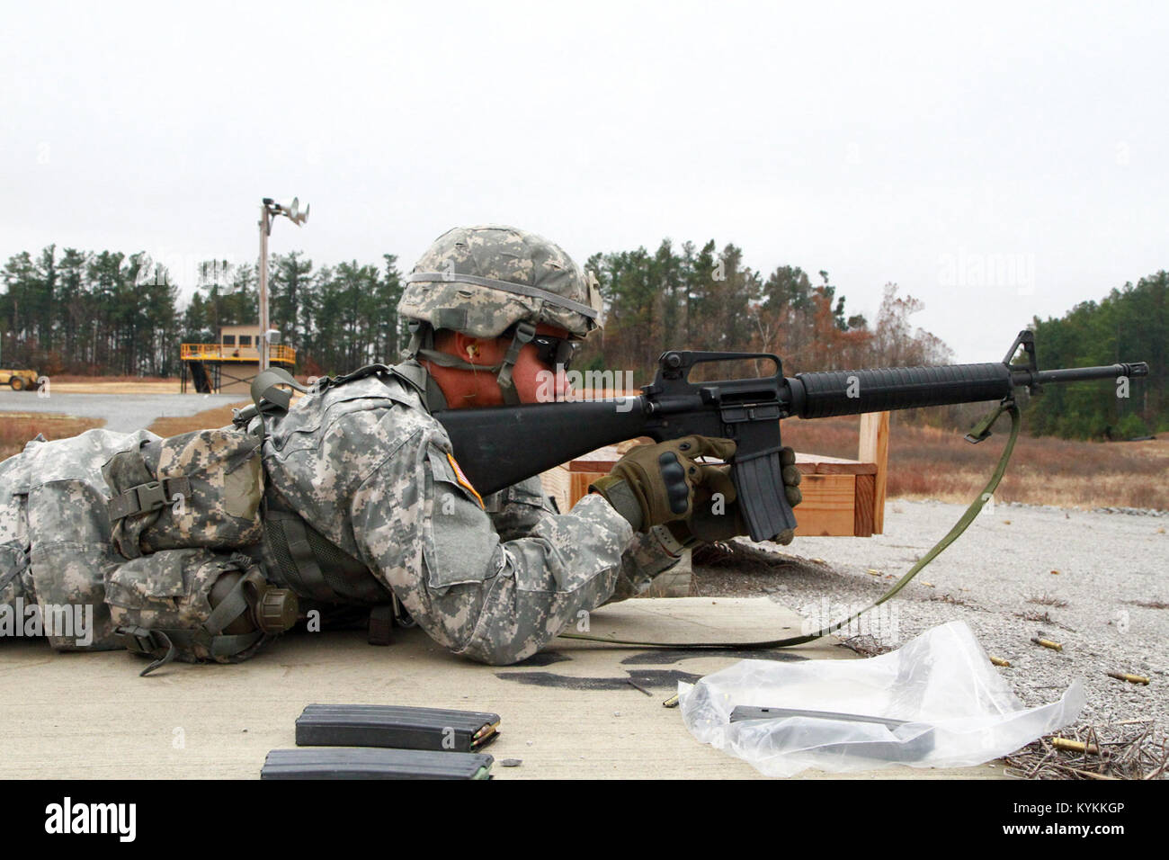 Spc. Christopher DeLeon with 75th Troop Command loads a magazine into ...