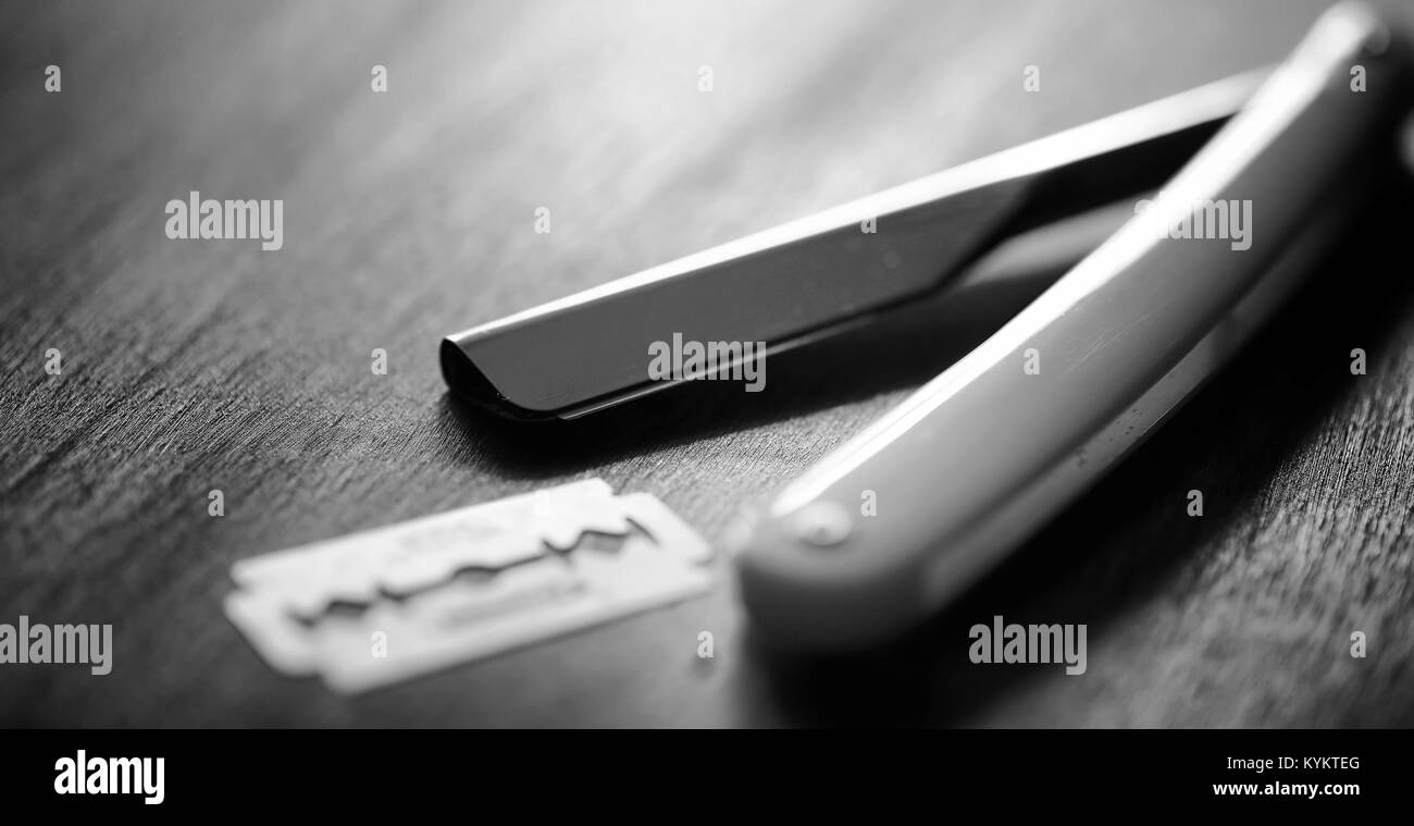A dangerous razor and a metal blade on the table. Men's shaving Stock ...