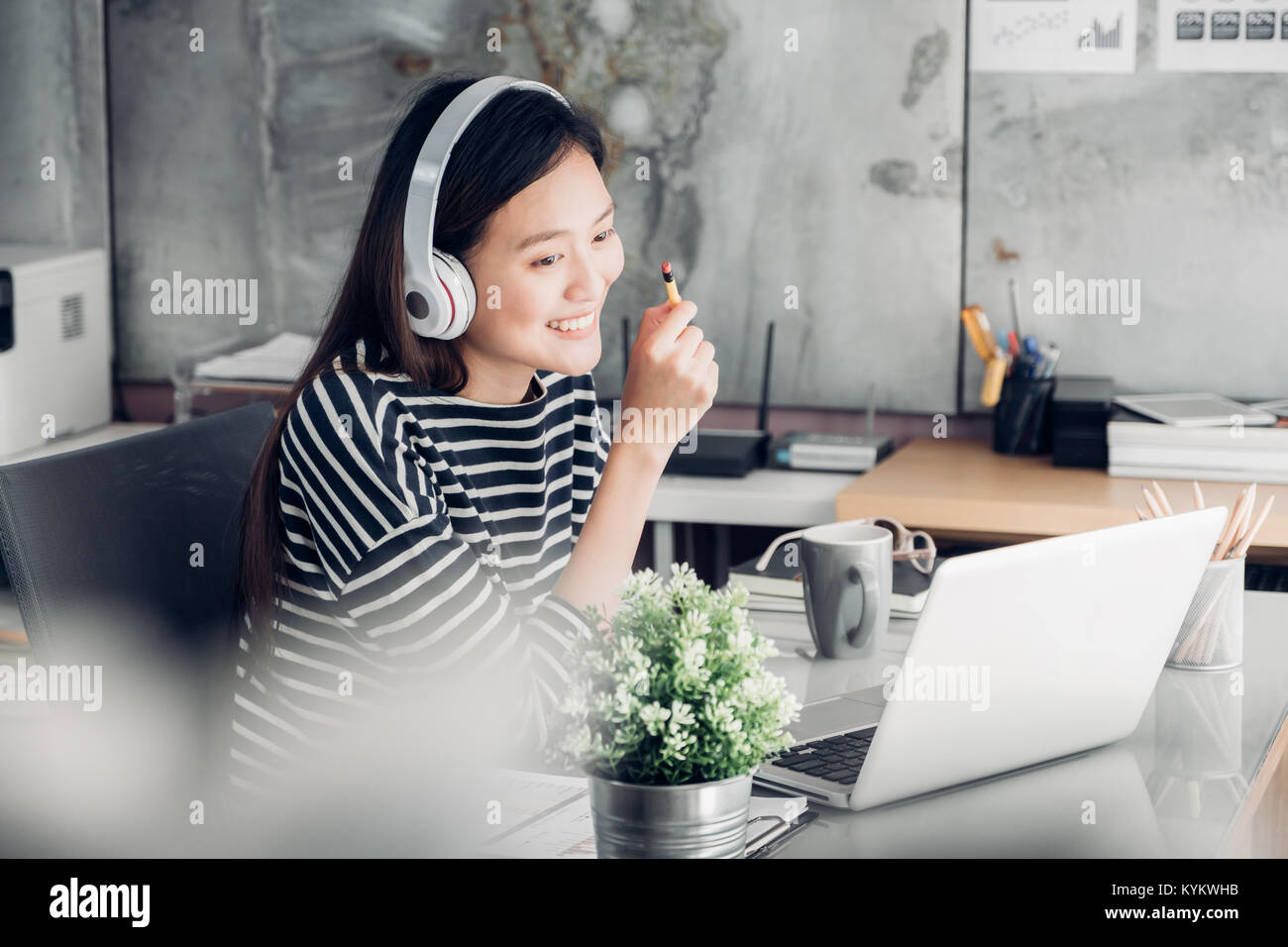 Young asian casual businesswoman arm on desk rest pose with laptop ...