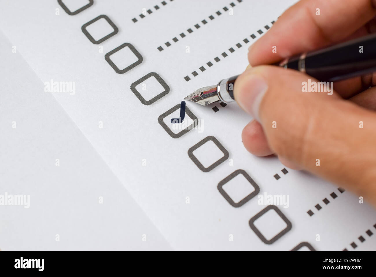 Check boxes on white a paper - closeup Stock Photo - Alamy