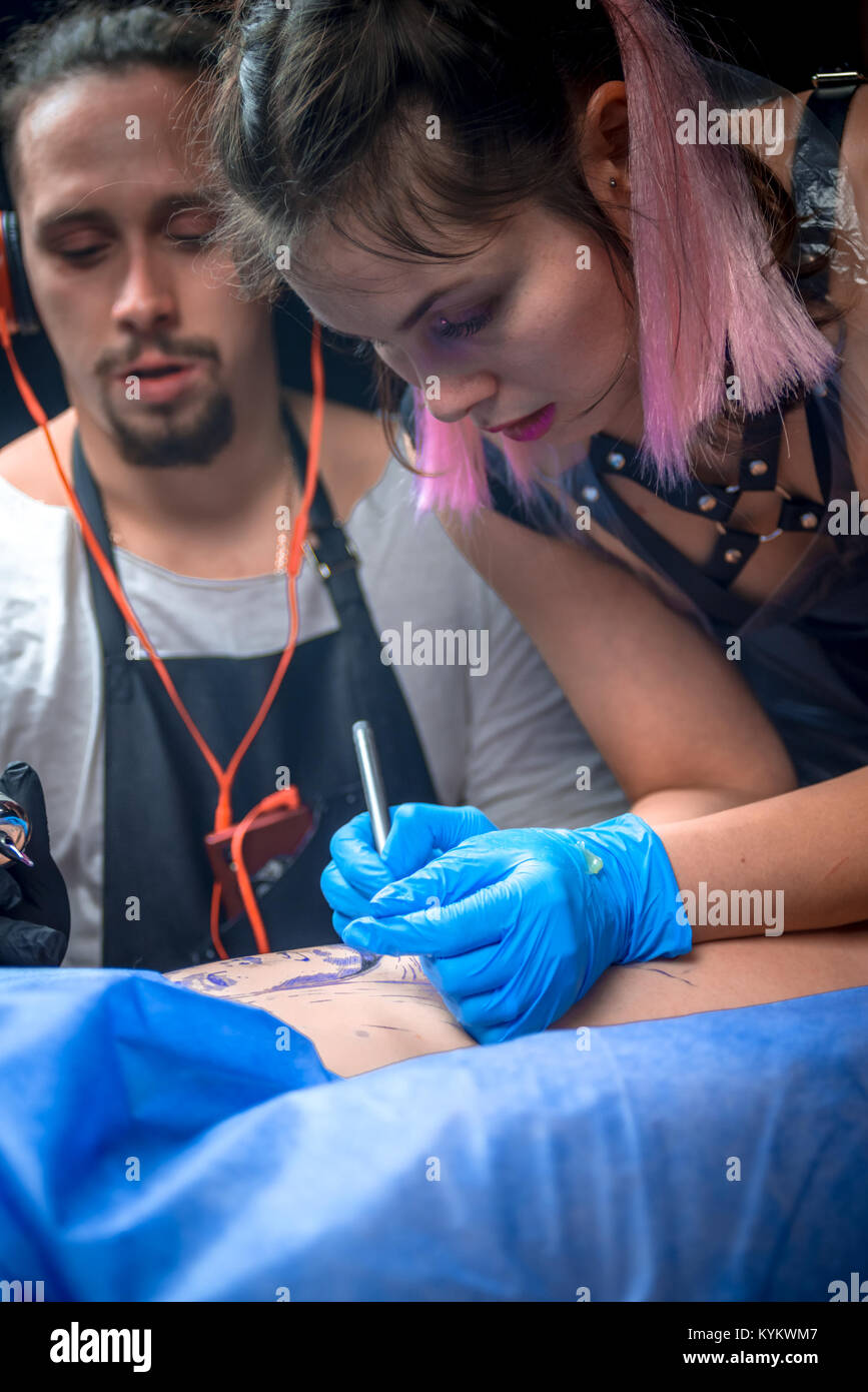 Tattoo artist demonstrates process hi-res stock photography and images ...