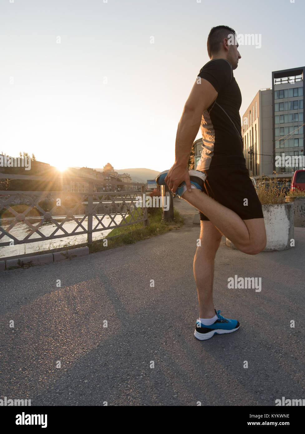 athlete man warming up and stretching while preparing for running on ...
