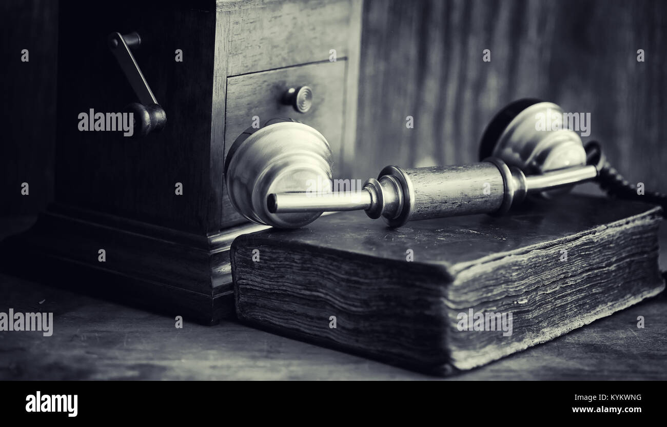Old telephone and retro book on the desk. The phone of the past Stock ...