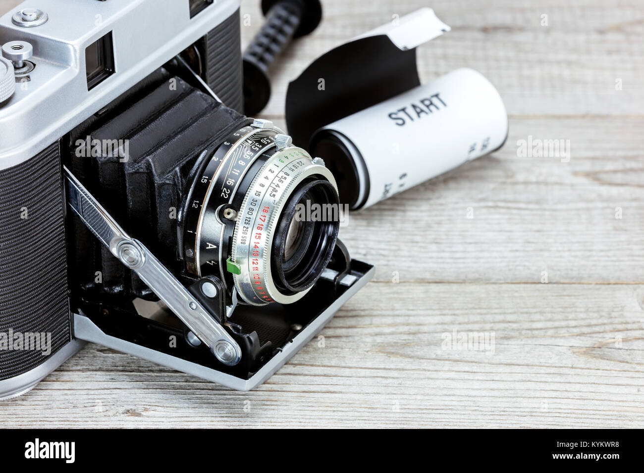 old retro camera with film roll, detailed closeup view on wooden ...