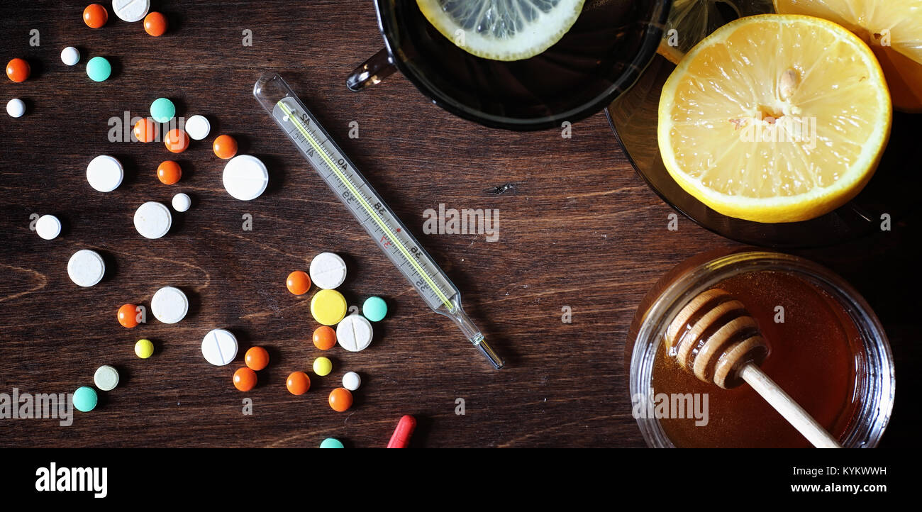Drugs and pills on a wooden table. Various means to prevent cold Stock ...