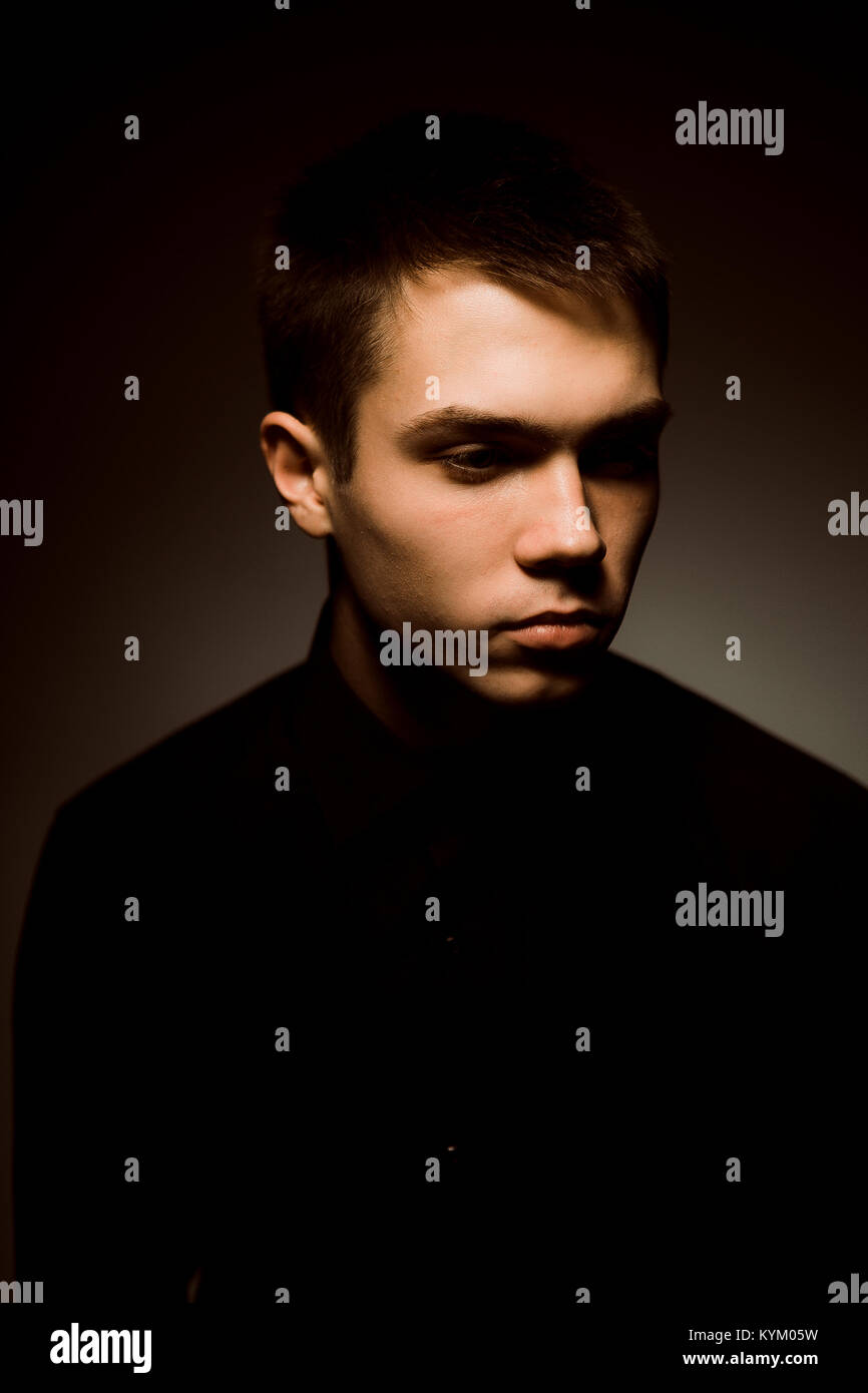young guy on a dark studio background Stock Photo - Alamy