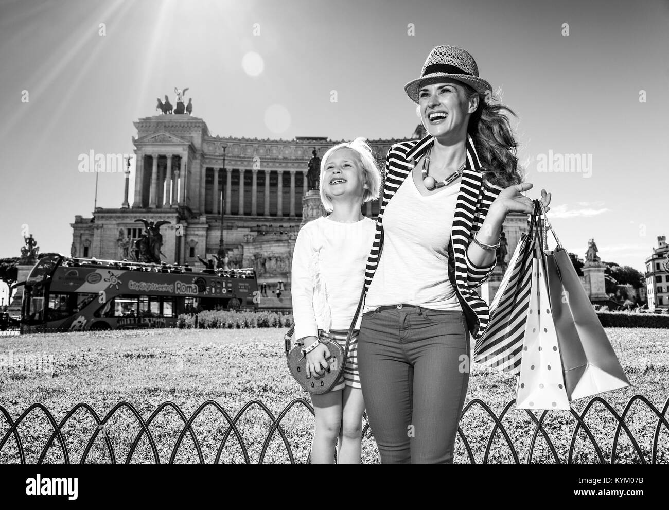 Roman Holiday. happy stylish mother and daughter travellers against ...