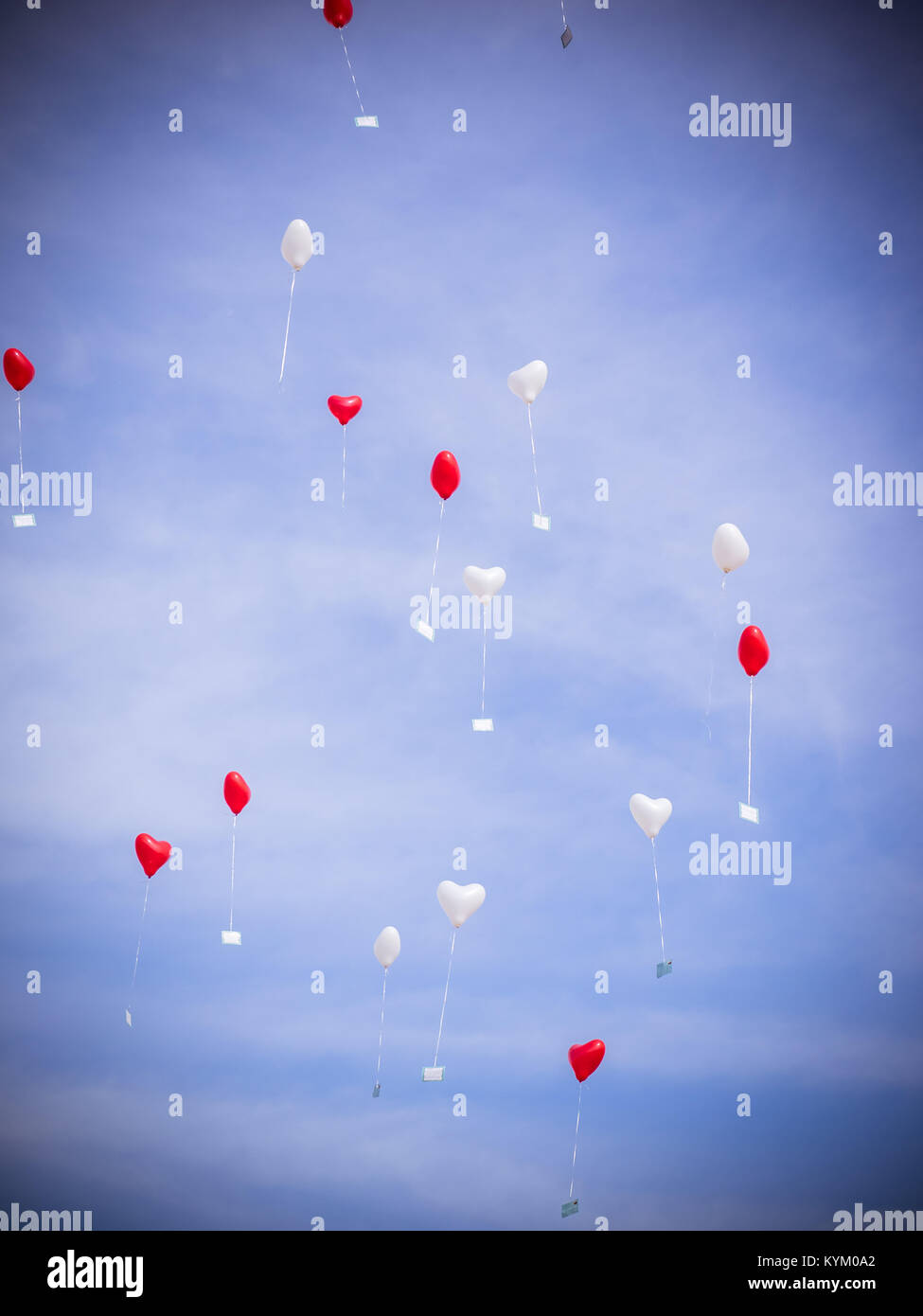 The red balloons fly in the sky for wedding Stock Photo - Alamy