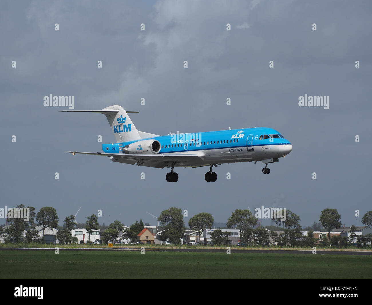 PH-KZK, a KLM Cityhopper Fokker F70, is captured landing on runway 18R ...