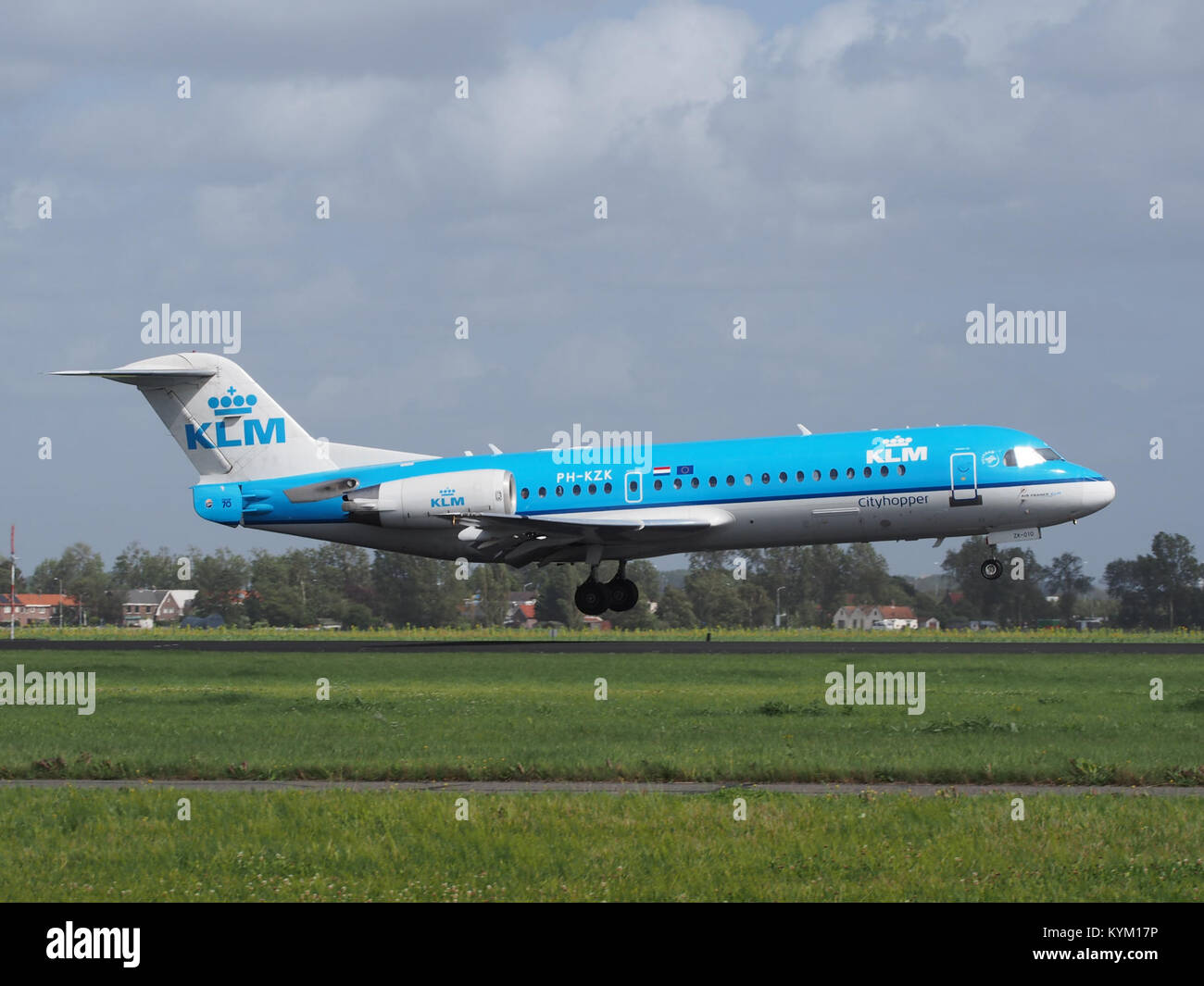 The PH-KZK KLM Cityhopper Fokker F70 is captured landing on runway 18R ...