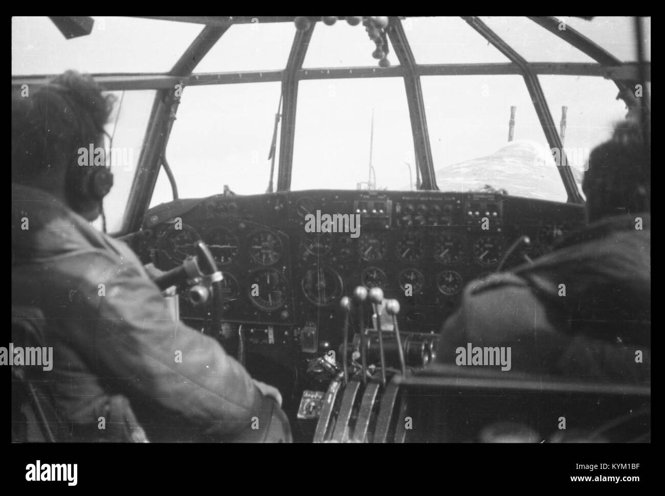 A photograph taken inside the cockpit of an aircraft, offering a close ...