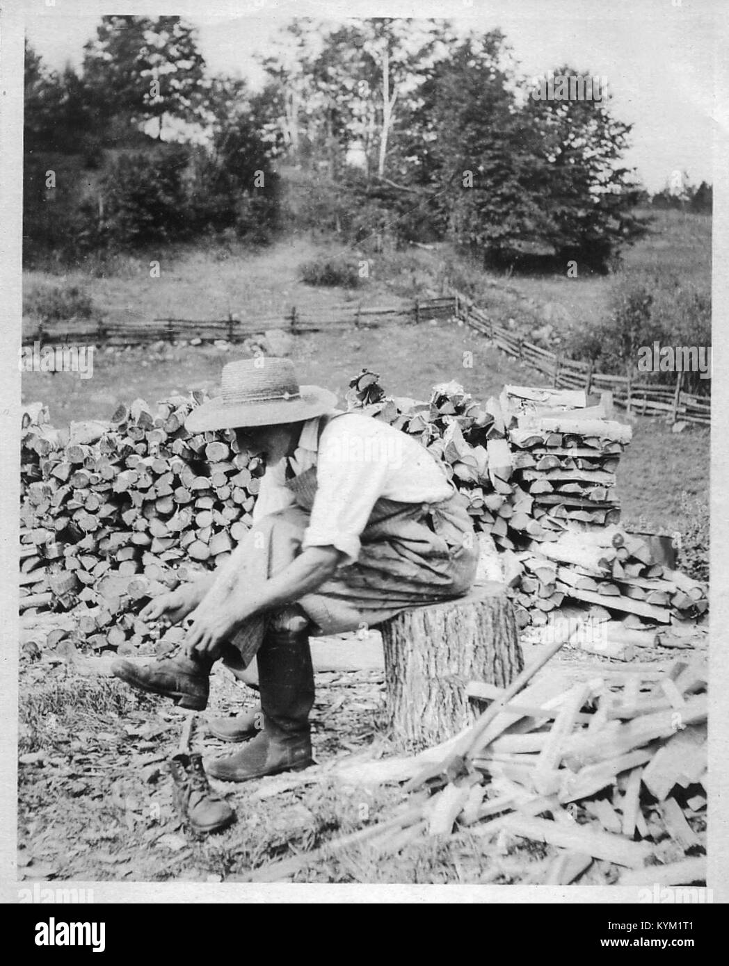 A vintage photograph of Henry Springer, a farmer resting beside a ...