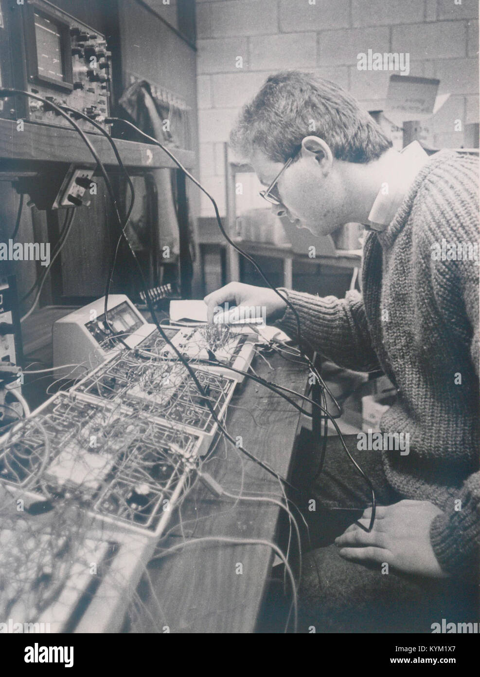 A historical photograph showing students working in electronics labs, likely from the mid-20th ...
