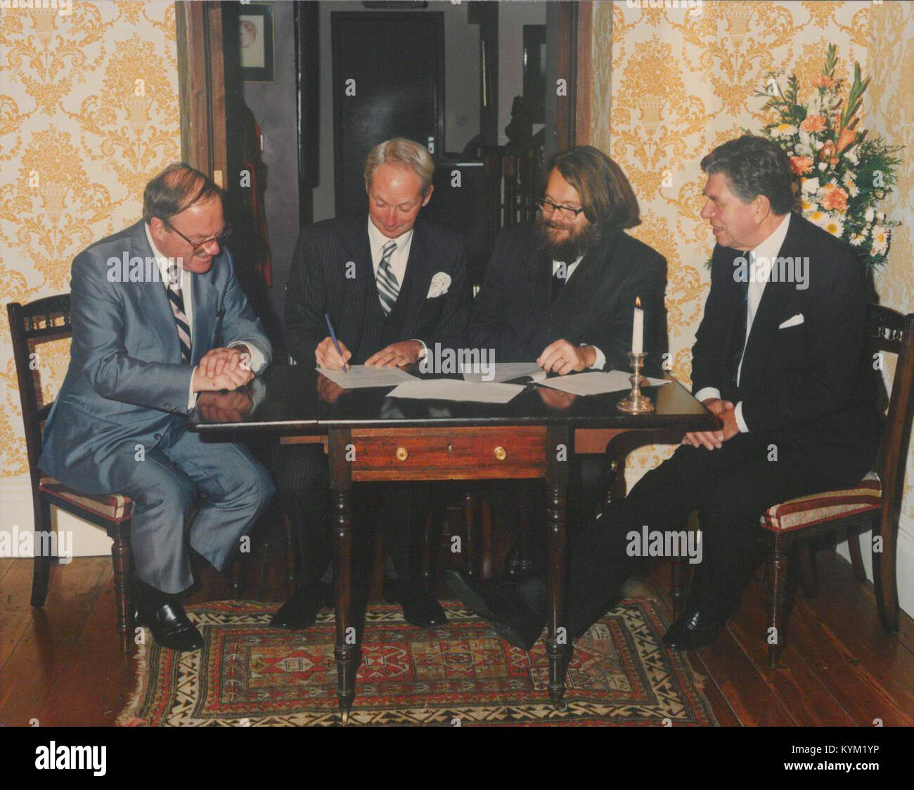 A historical photograph capturing the signing of an inter-university ...