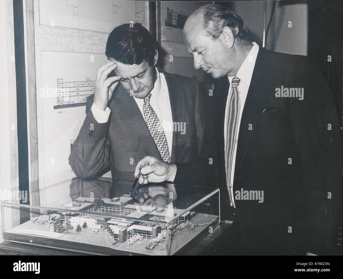 A photograph of Des O'Malley TD and Pat Whelan, architect, examining a ...