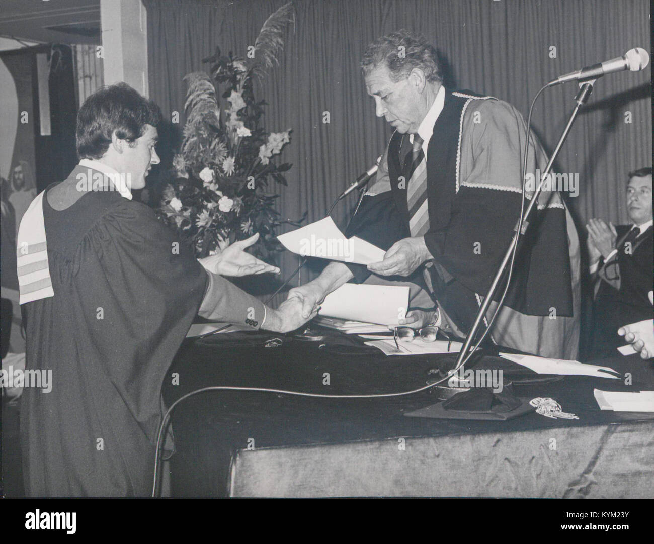 A photograph from 1980 showing a graduate receiving their parchment at ...
