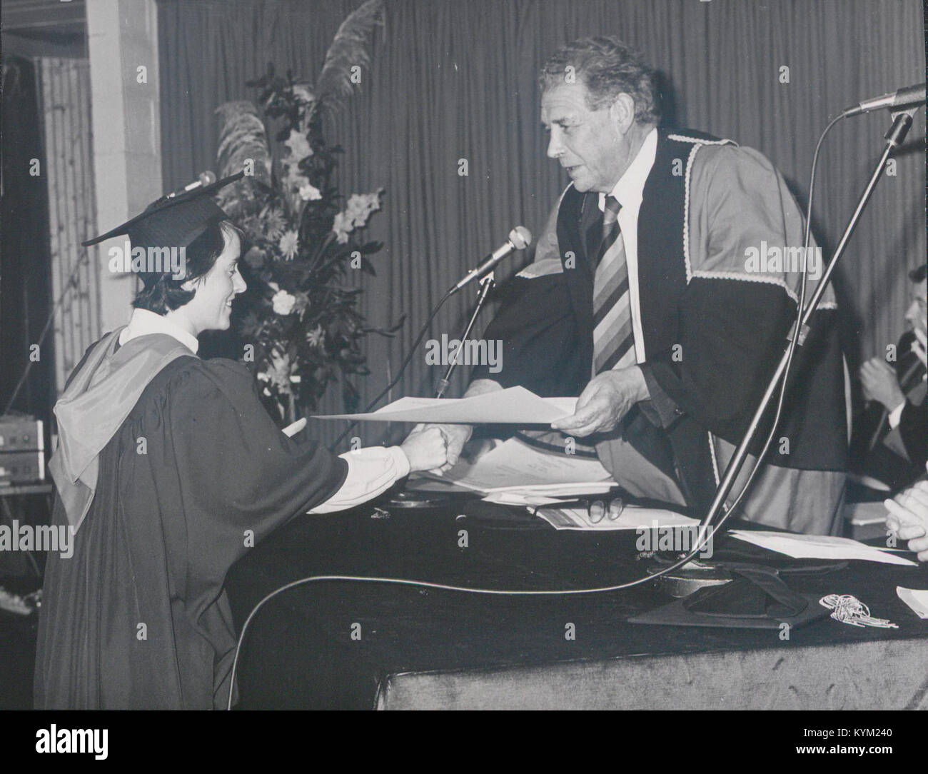 A photograph from 1980 depicting a graduate receiving her diploma ...