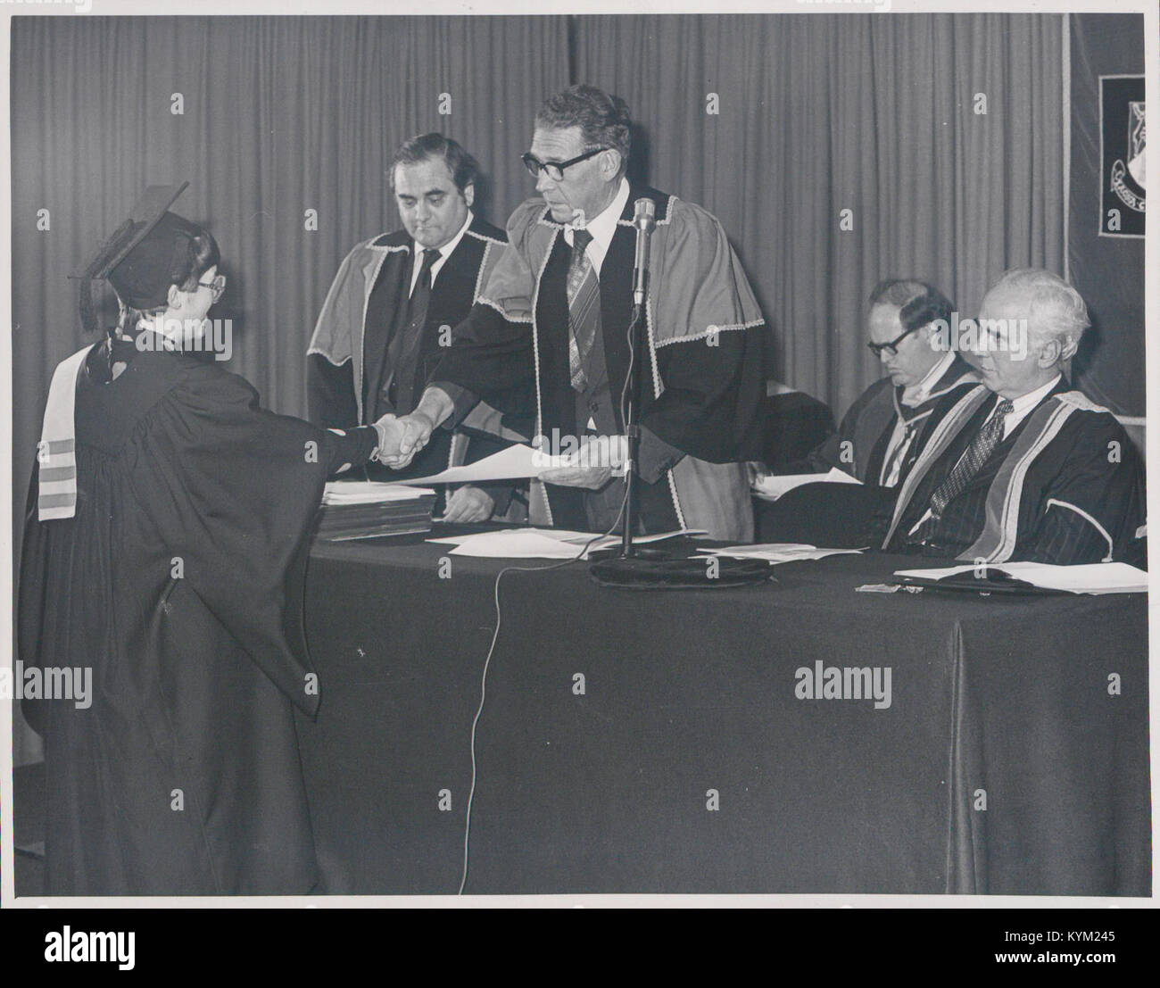A graduate receiving their parchment at a conferring ceremony in 1979 ...