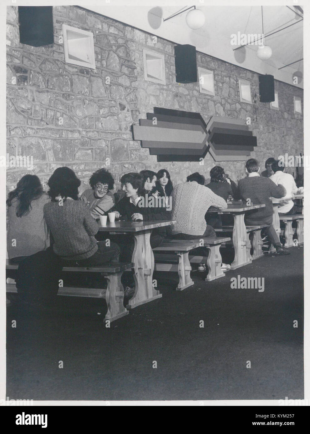 A photograph of students gathered in the common room of the Campus ...
