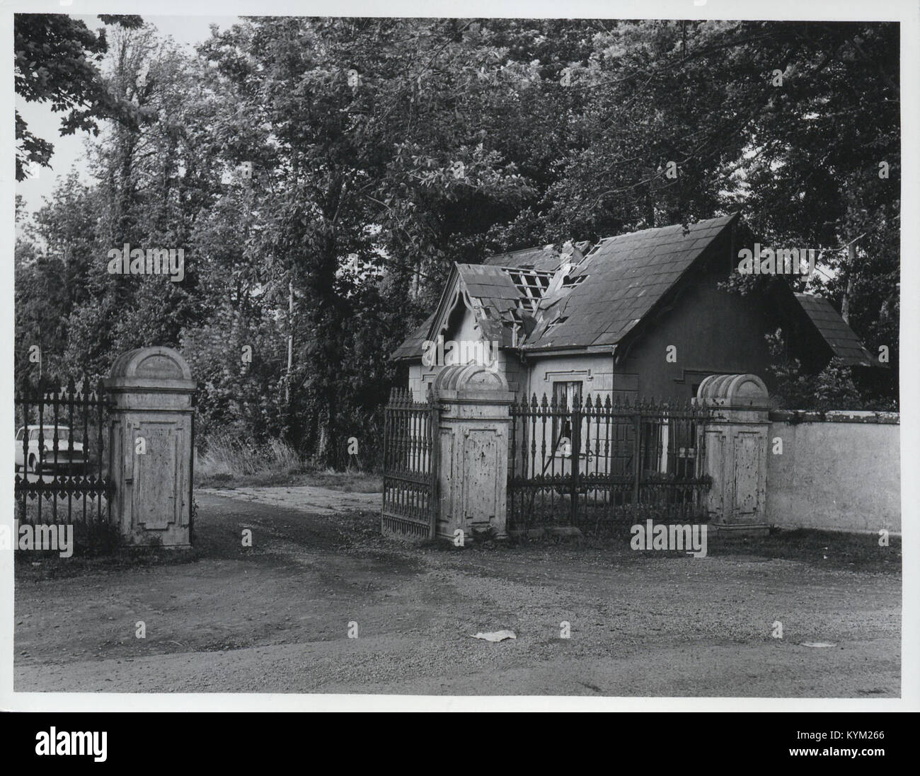 This photograph depicts the side view of a gate lodge, showing its ...