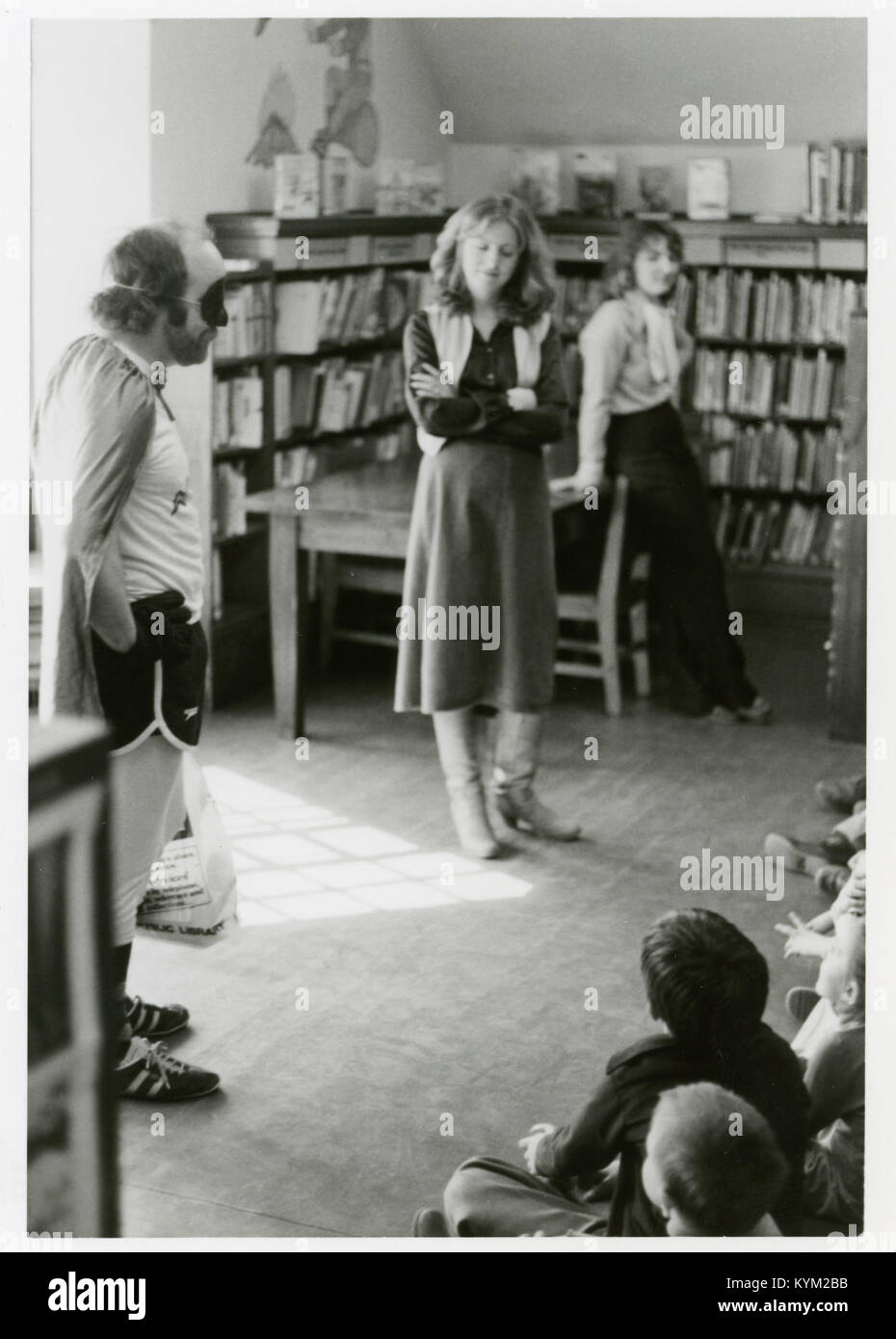 A historic photograph showing a librarian reading during story time at ...