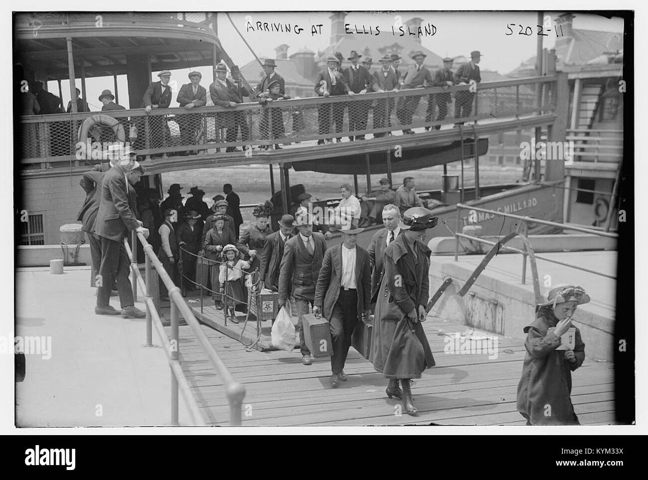 A historic photograph of immigrants arriving at Ellis Island, captured ...