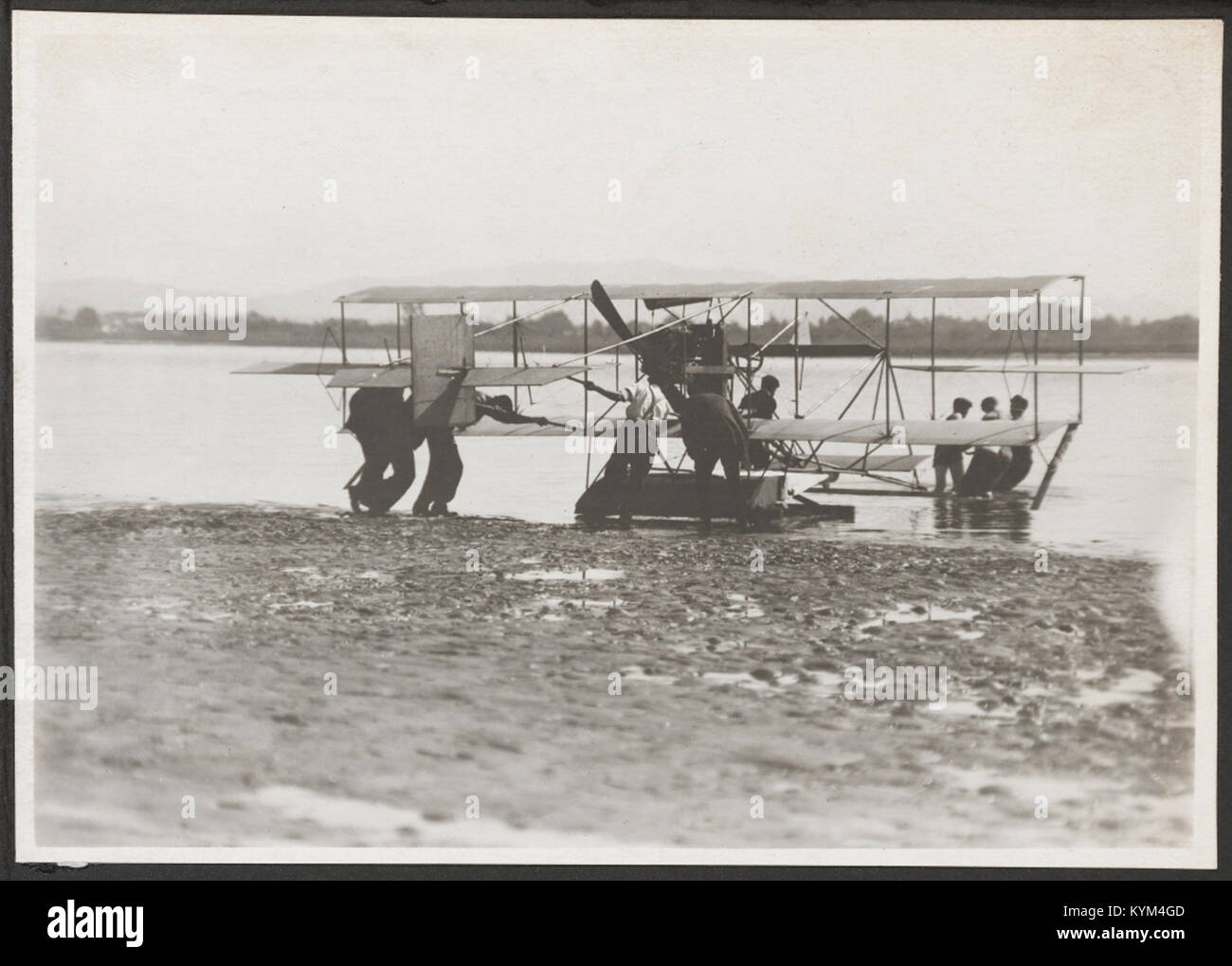 A historical photograph showing crew members positioning a Curtiss ...