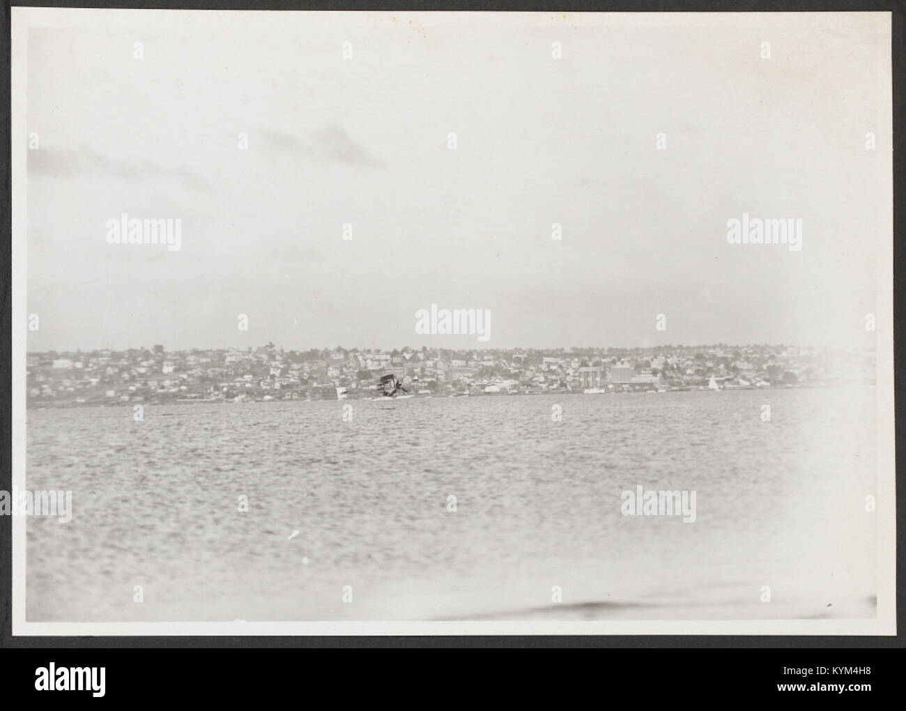 Curtiss Pusher floatplane in flight over San Diego Bay, captured in an ...