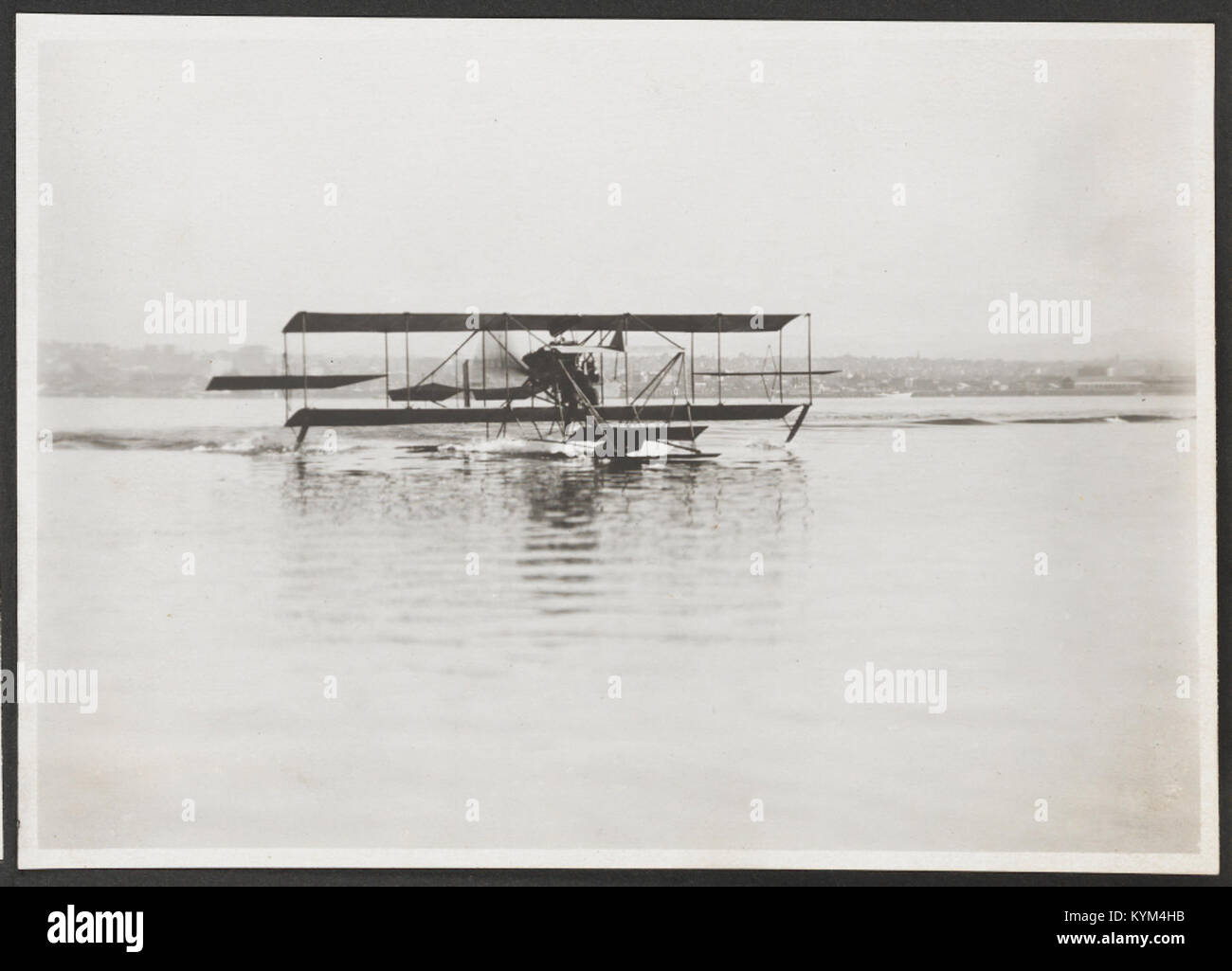 A Curtiss Pusher floatplane flying over San Diego Bay, showcasing early ...