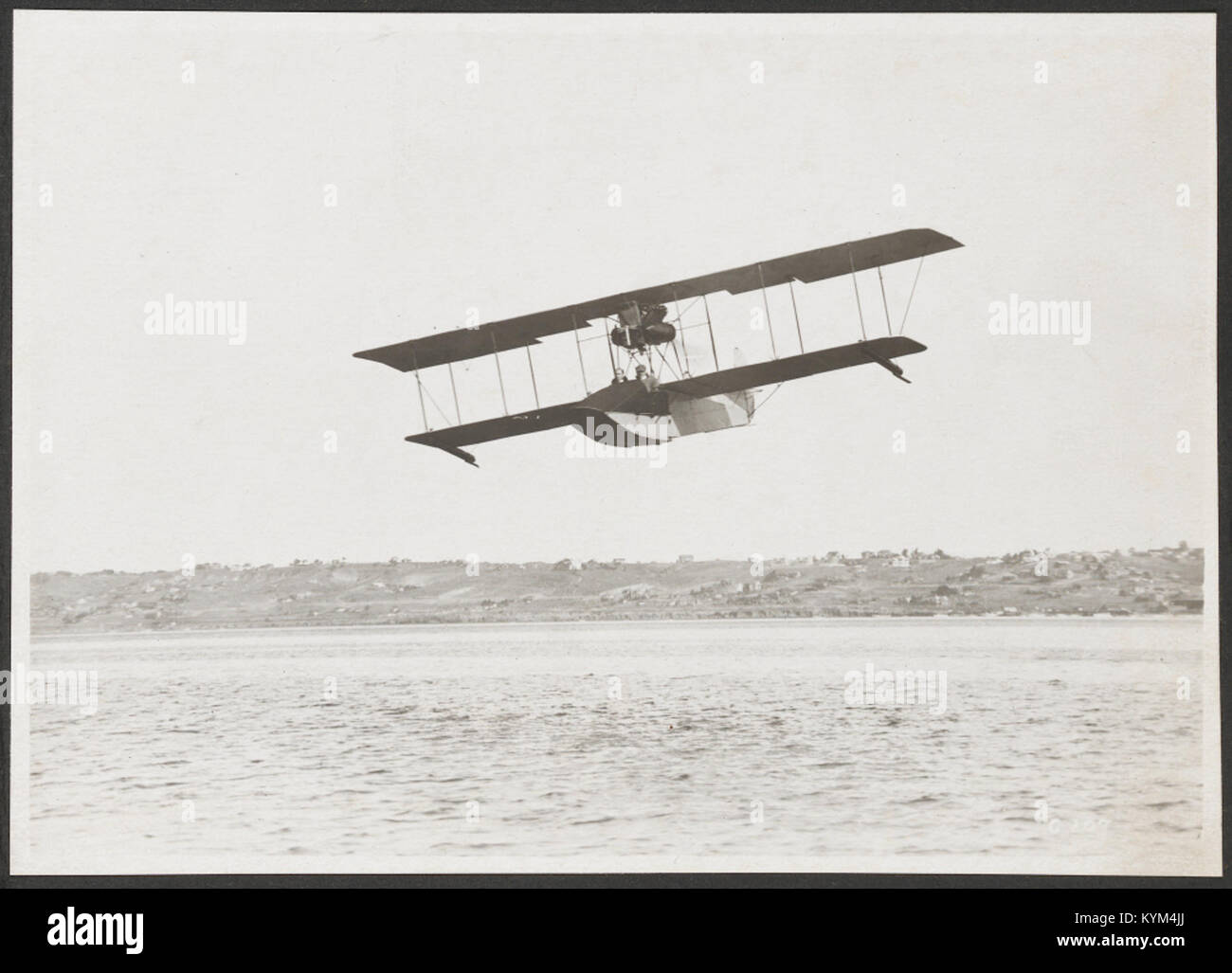 A Curtiss F-Boat flying over San Diego Bay, captured in a historic ...