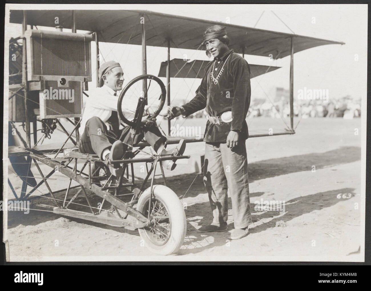 A photograph showing Art Smith, an aviator, shaking hands with a Native ...