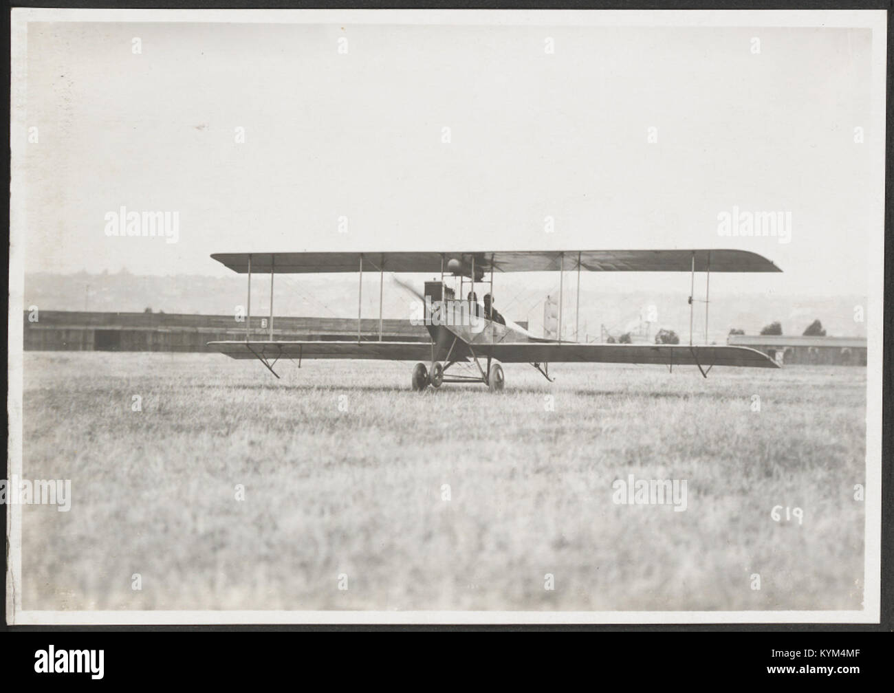 A biplane takes off, capturing the early days of aviation. This ...
