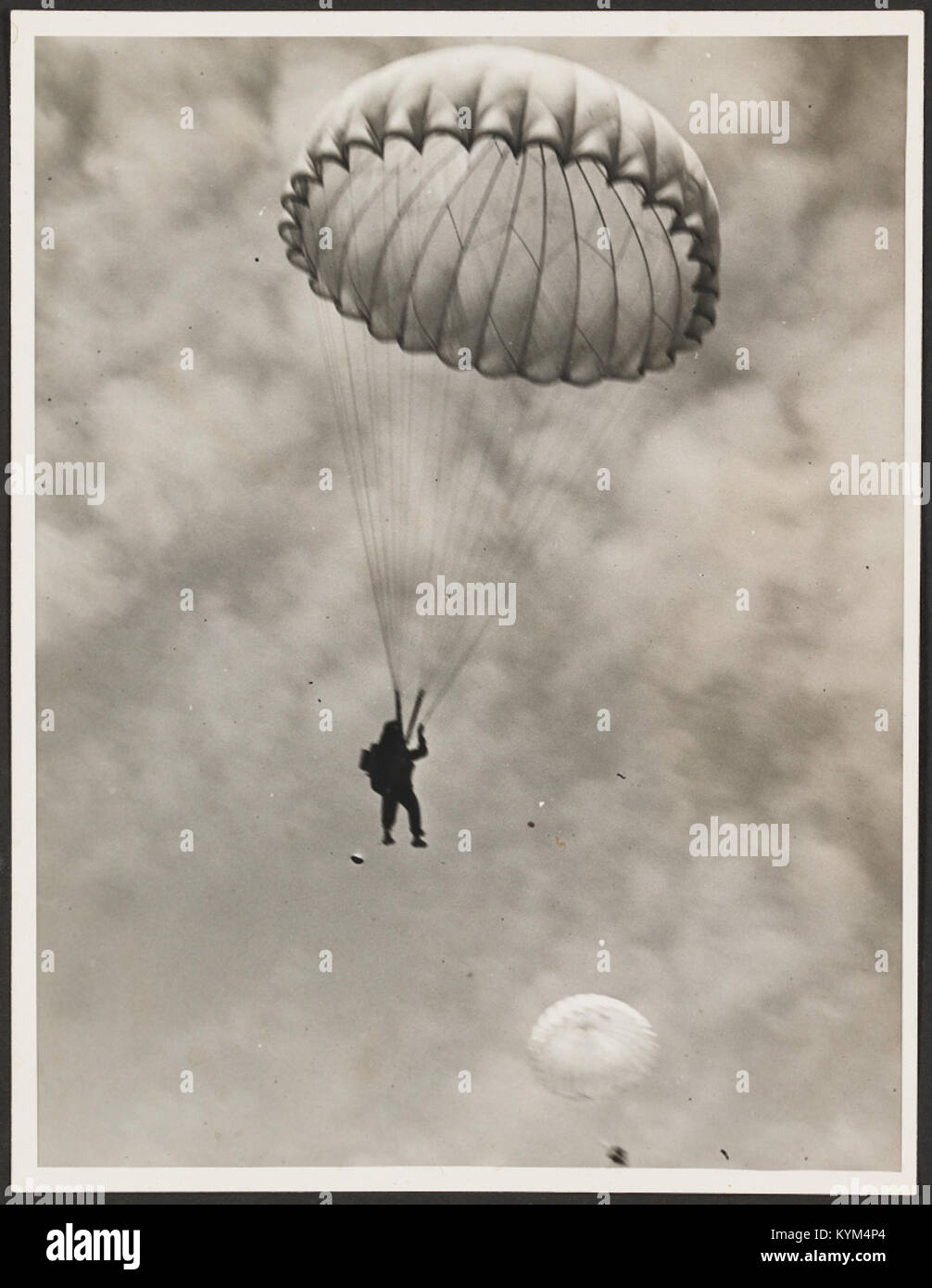 A historical image documenting a parachute jump, possibly from the ...