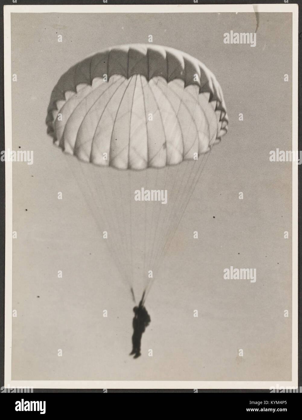 An image of a parachutist during descent, captured as part of early ...