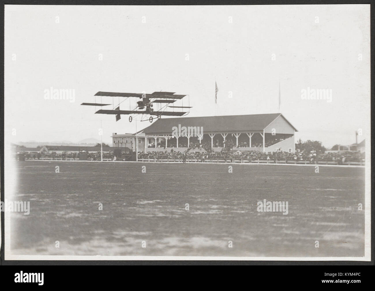 A photograph showing a Curtiss Pusher aircraft in flight. The image ...