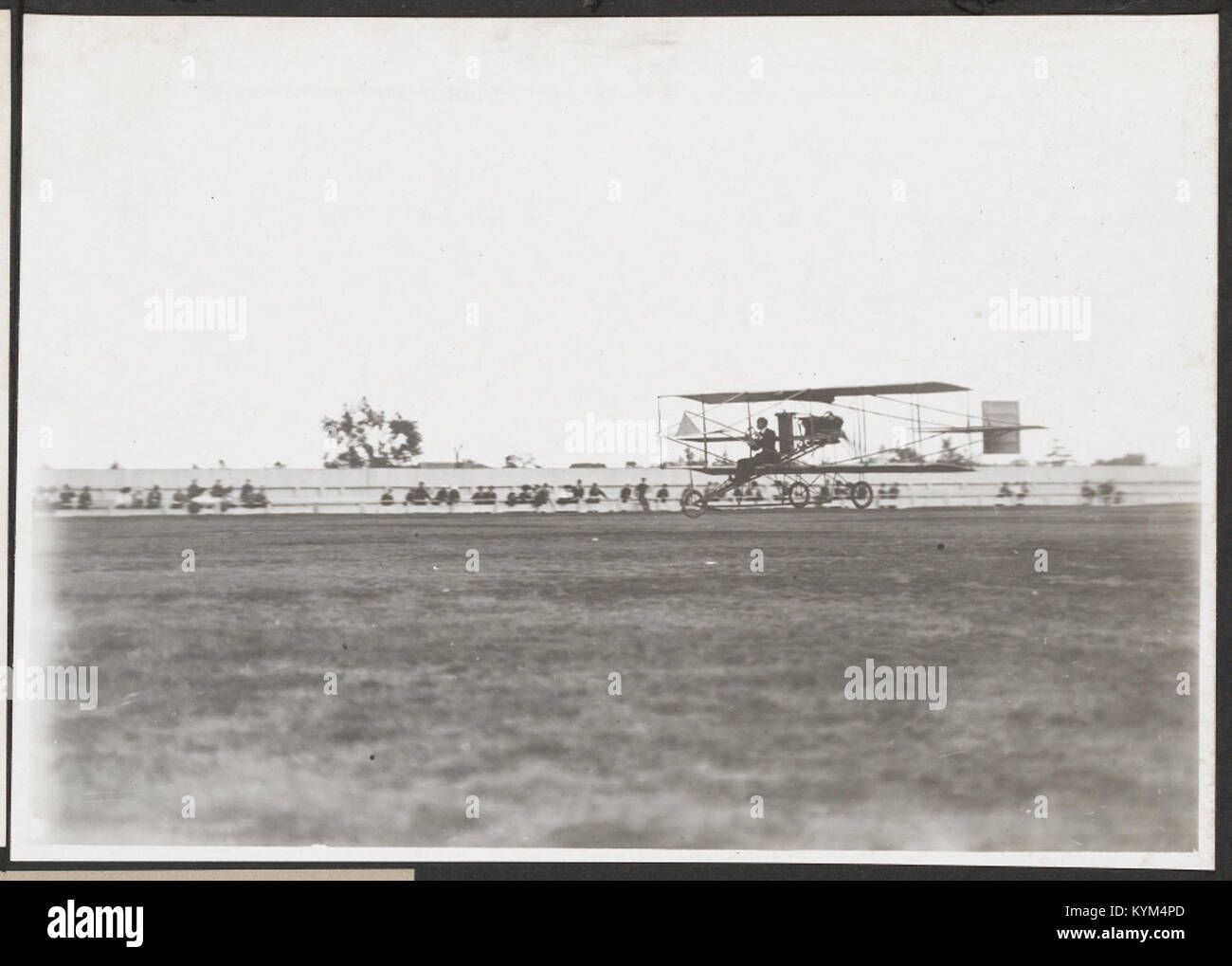 A photograph showing a Curtiss Pusher aircraft making a landing at the ...