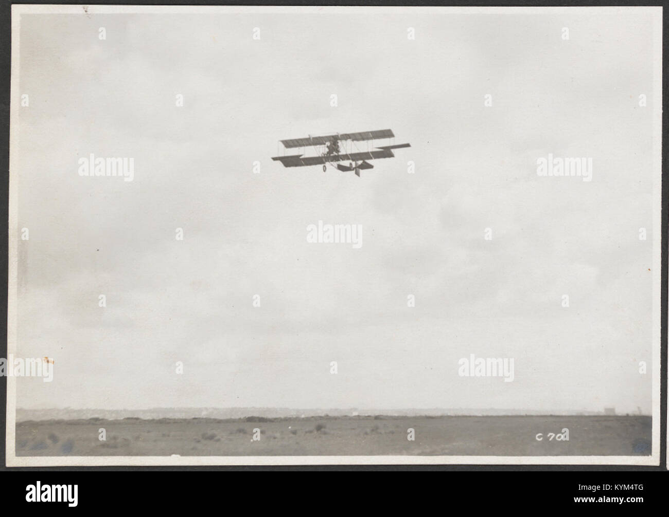 A photograph of a Curtiss Pusher biplane in flight, taken at the ...
